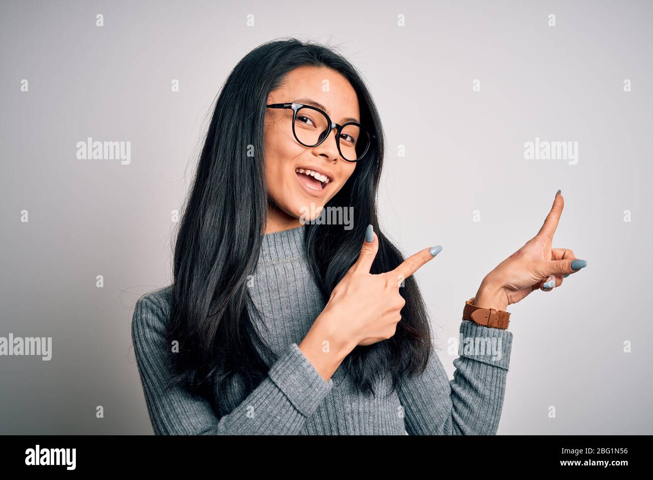Young beautiful chinese woman wearing glasses and sweater over isolated ...