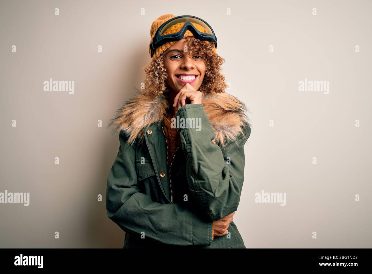 Young african american skier woman with curly hair wearing snow ...