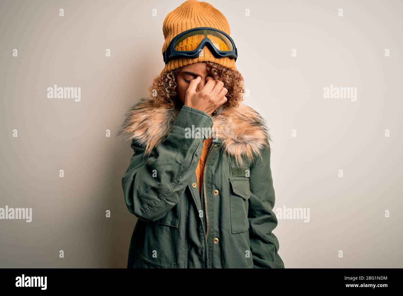 Young african american skier woman with curly hair wearing snow ...