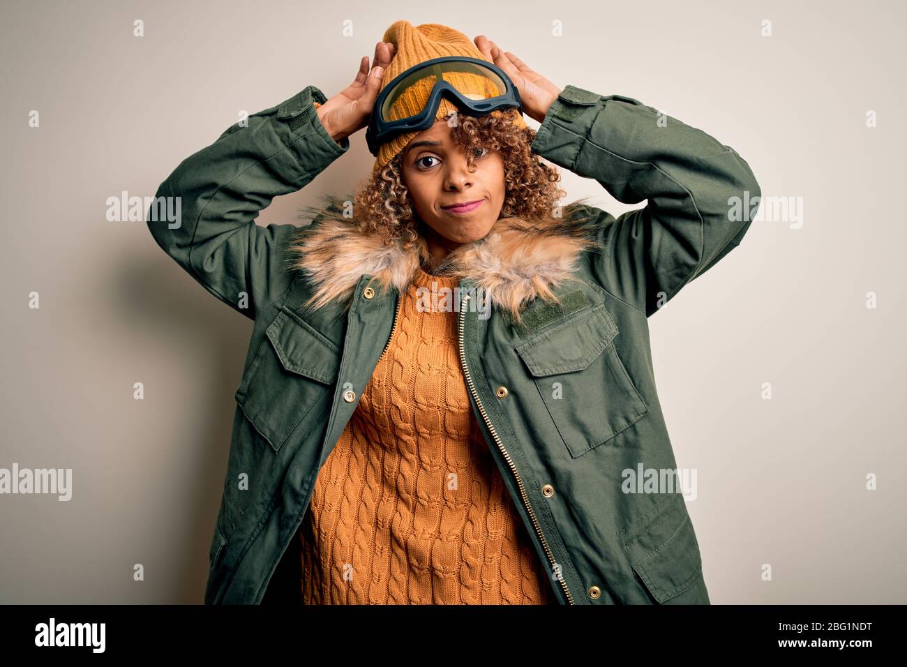 Young african american skier woman with curly hair wearing snow ...