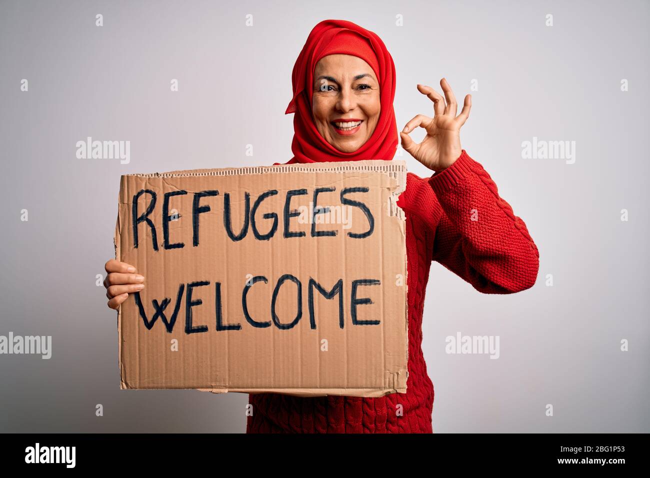 Woman wearing muslim hijab asking for immigration holding welcome ...