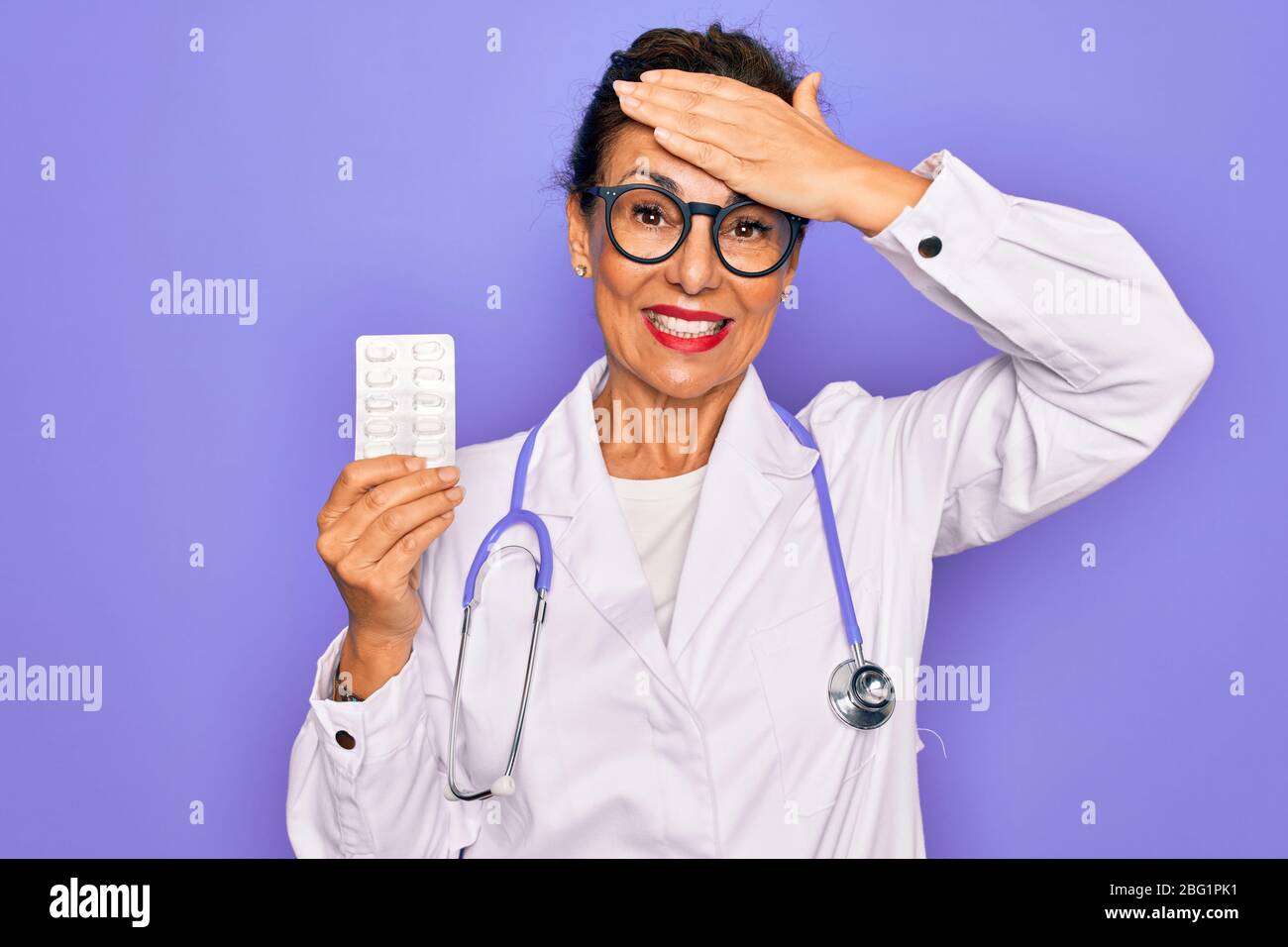 Middle age senior professional doctor woman holding pharmaceutical ...