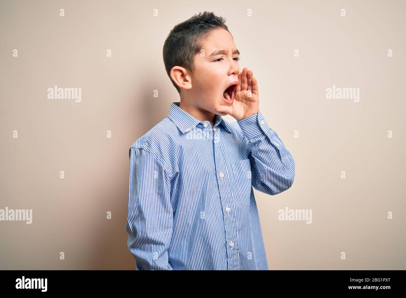 Young little boy kid wearing elegant shirt standing over isolated ...