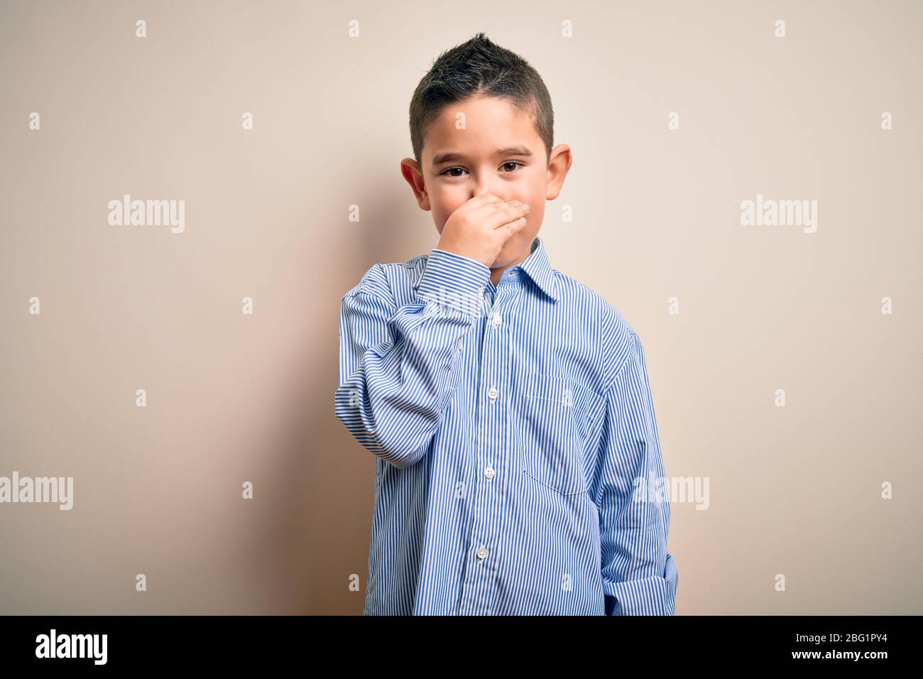 Young little boy kid wearing elegant shirt standing over isolated ...