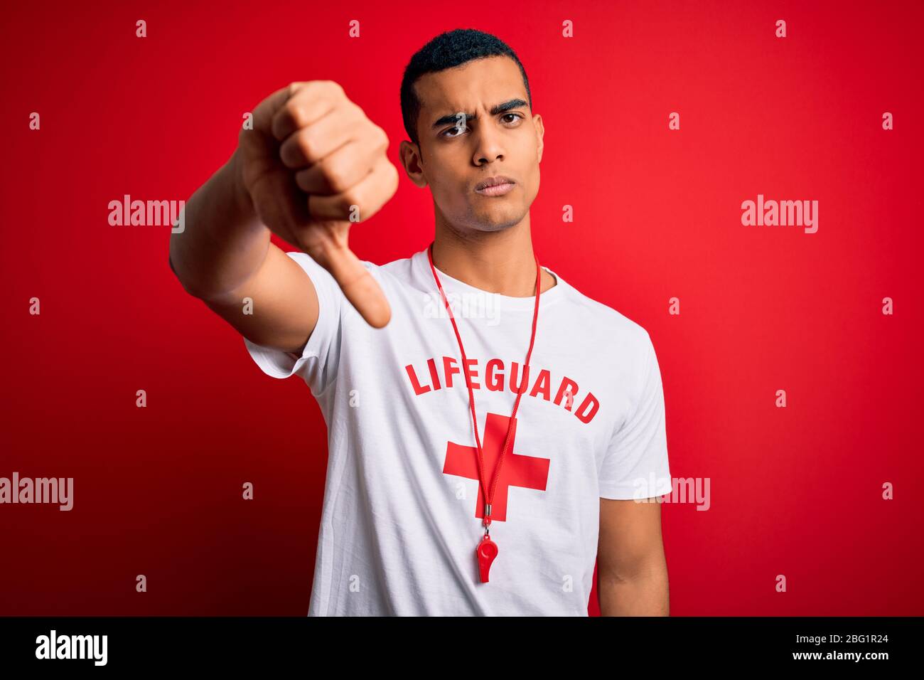 Young handsome african american lifeguard man wearing t-shirt with red ...