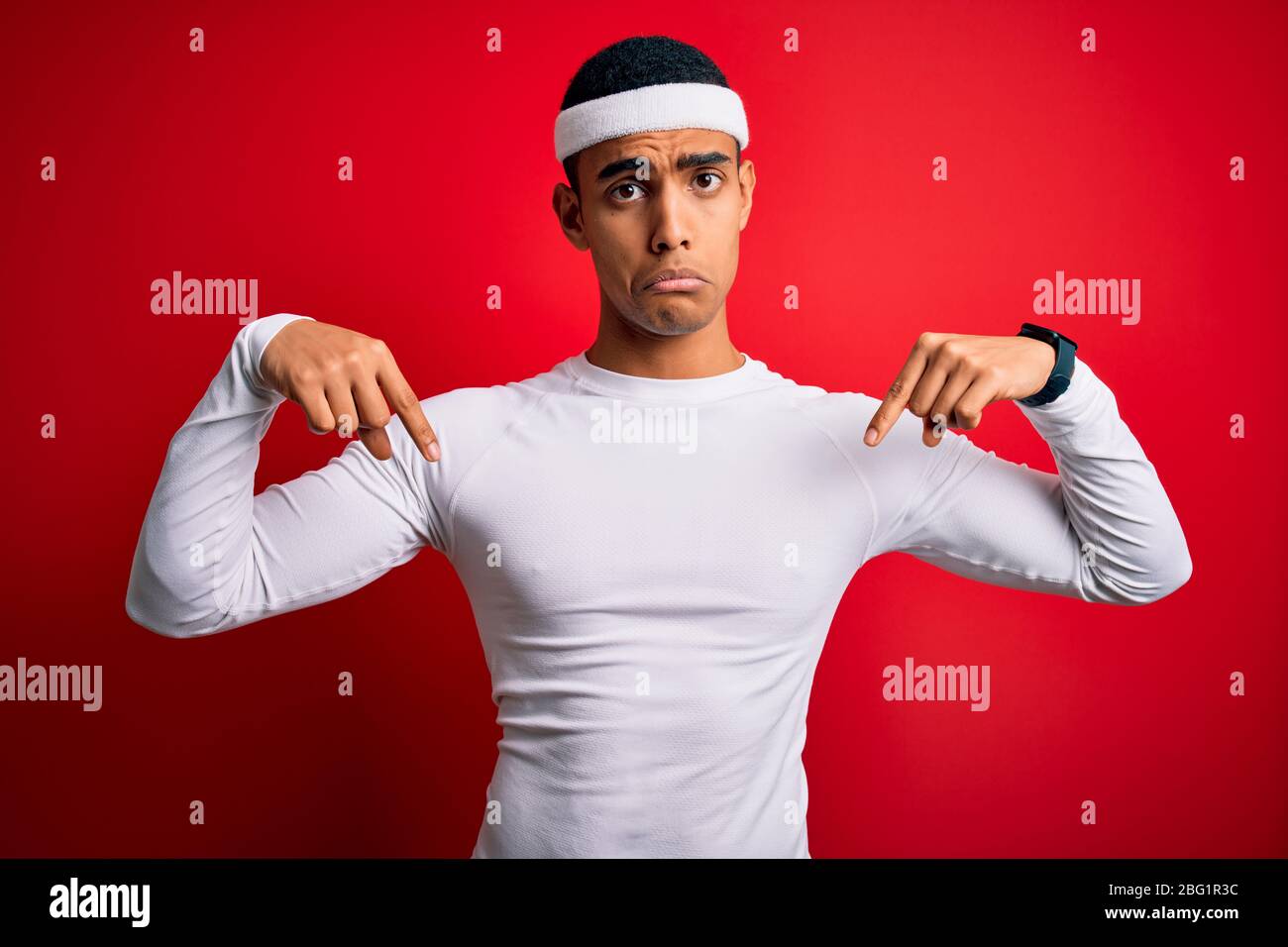Young handsome african american sportsman wearing sportswear over red ...