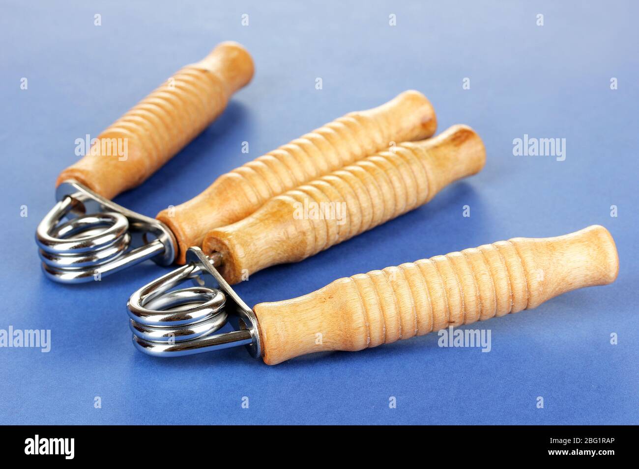 Modern hand trainer on blue background Stock Photo - Alamy