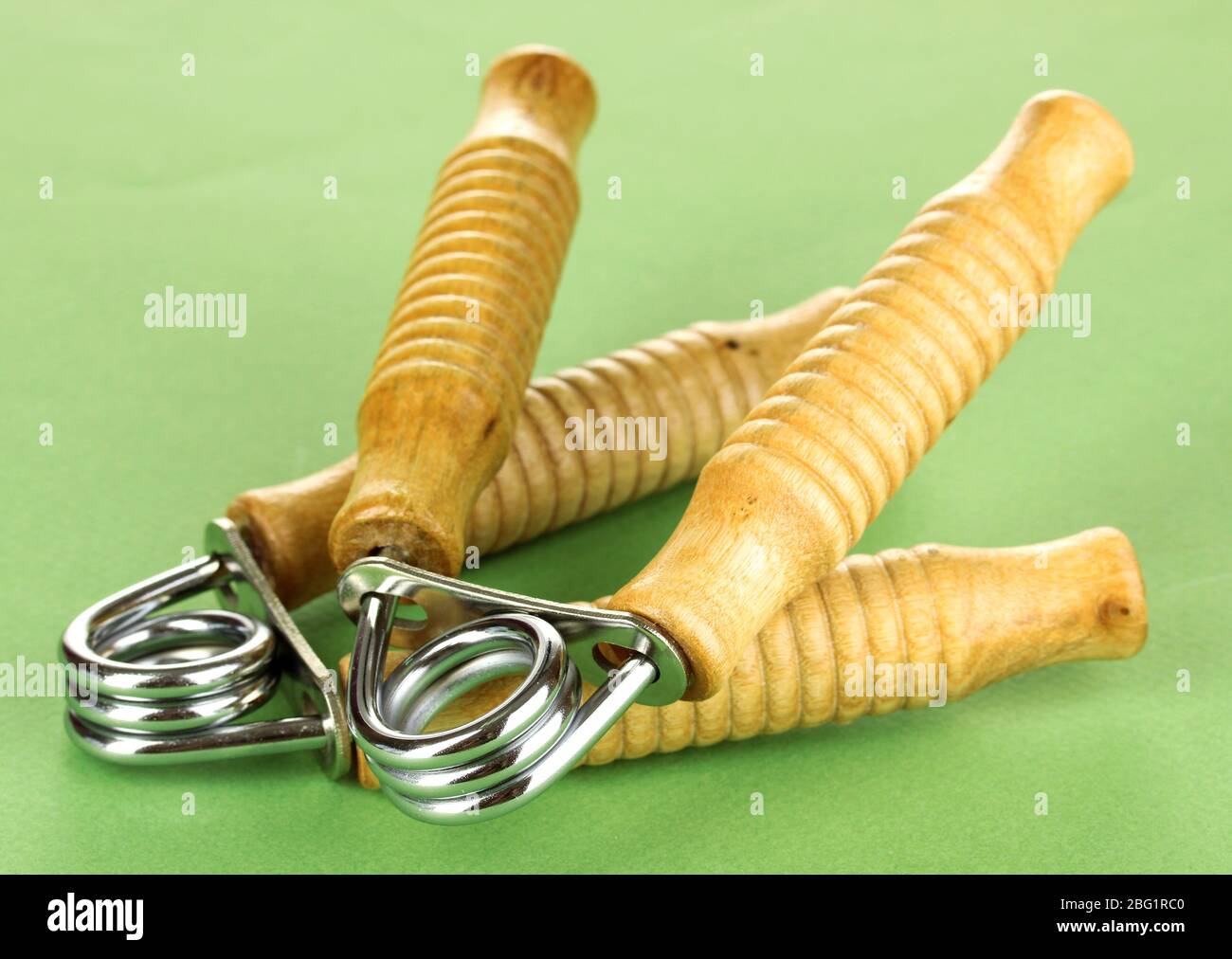 Modern hand trainer on green background Stock Photo - Alamy