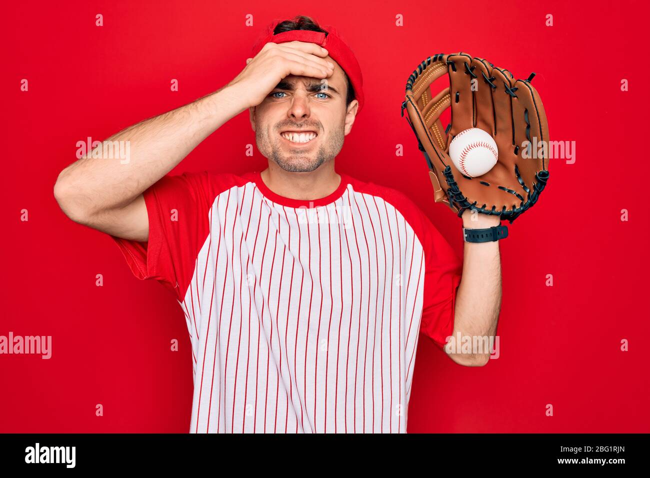 Young handsome sporty man with blue eyes playing baseball using glove ...