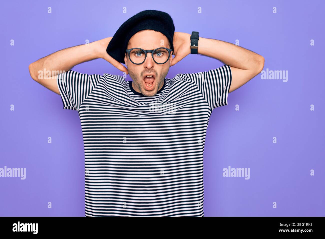 Handsome man with blue eyes wearing striped t-shirt and french beret ...