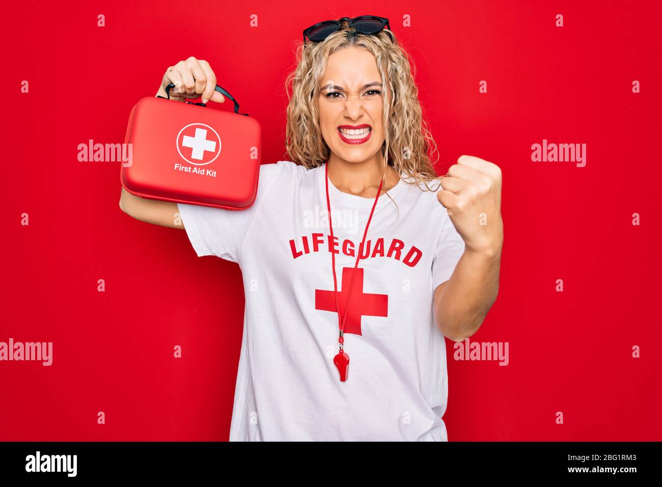 Beautiful blonde lifeguard woman wearing t-shirt with red cross and ...