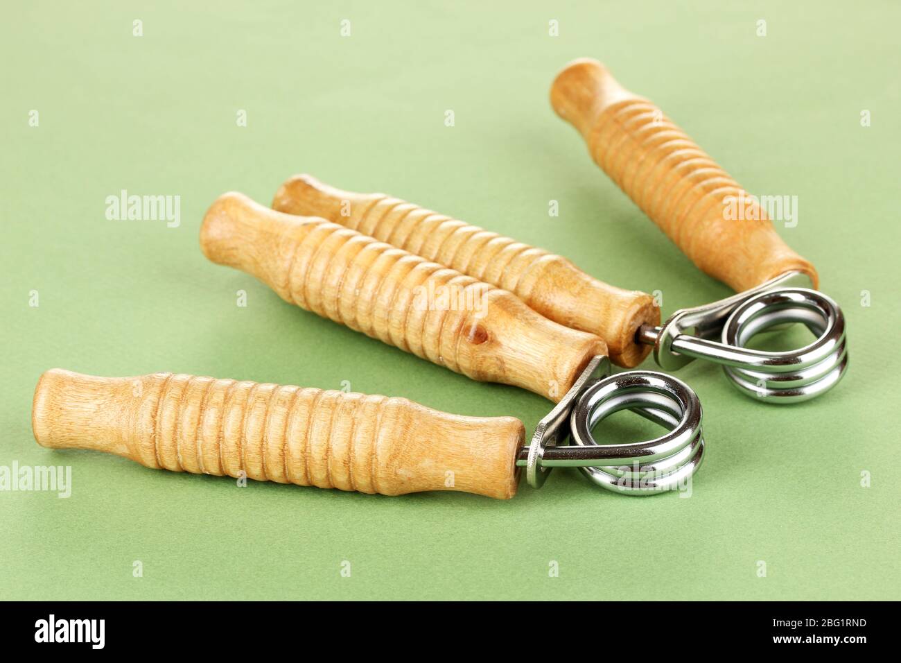 Modern hand trainer on green background Stock Photo - Alamy