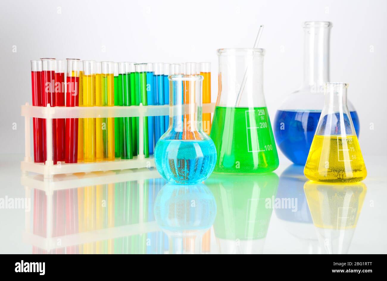 Test tubes with colorful liquids isolated on white Stock Photo - Alamy