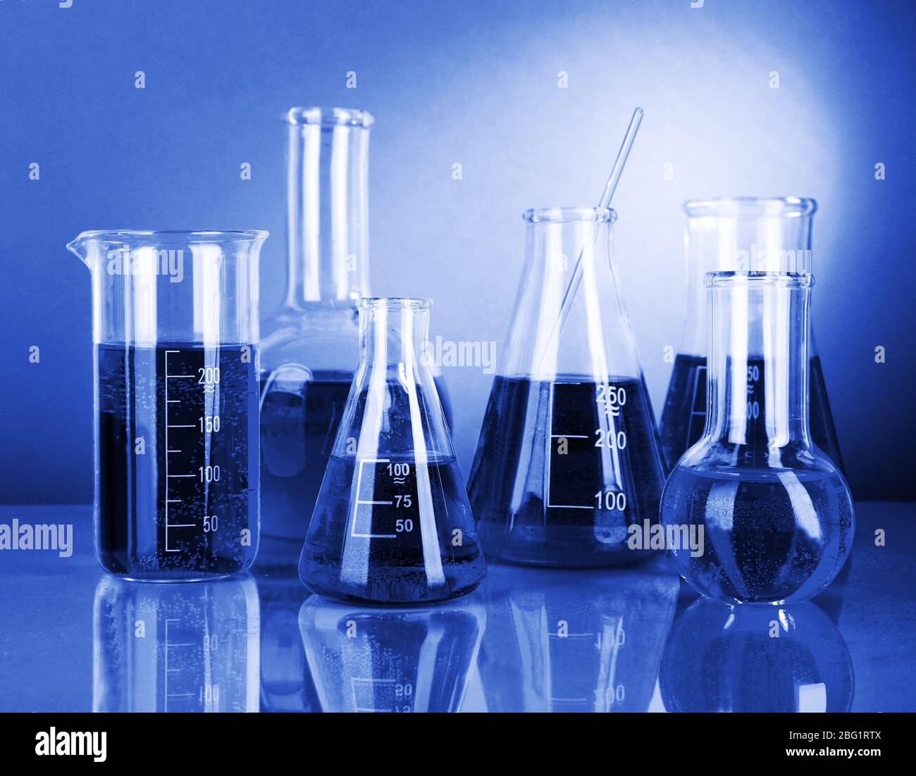 Test tubes with colorful liquids in blue light Stock Photo - Alamy
