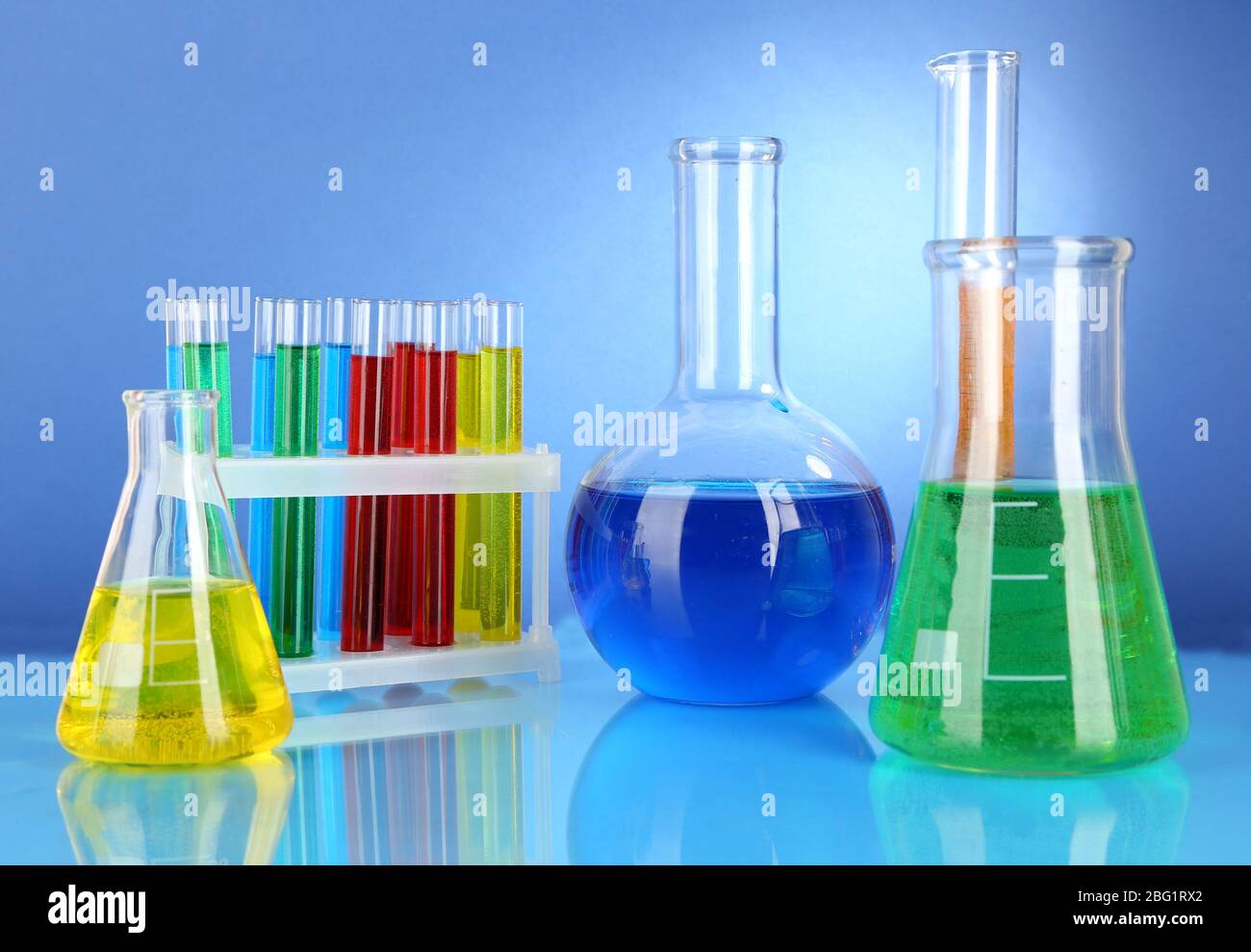 Test tubes with colorful liquids on blue background Stock Photo - Alamy