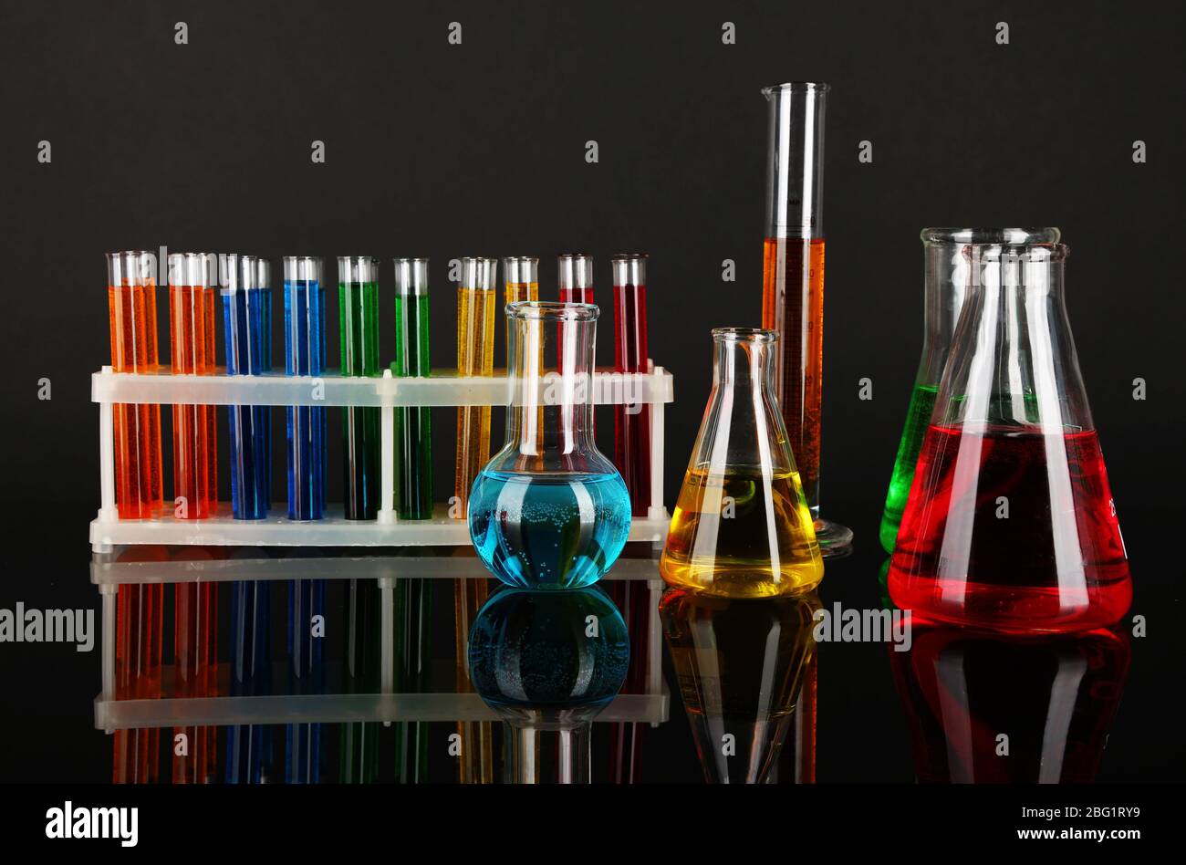 Test tubes with colorful liquids on dark grey background Stock Photo ...
