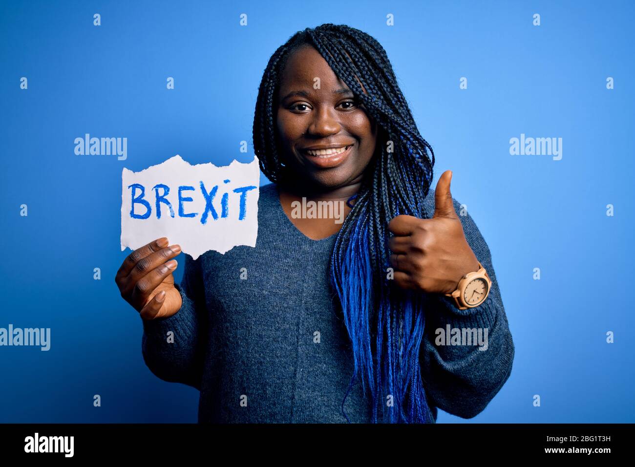 Young african american plus size woman with braids holding paper with ...