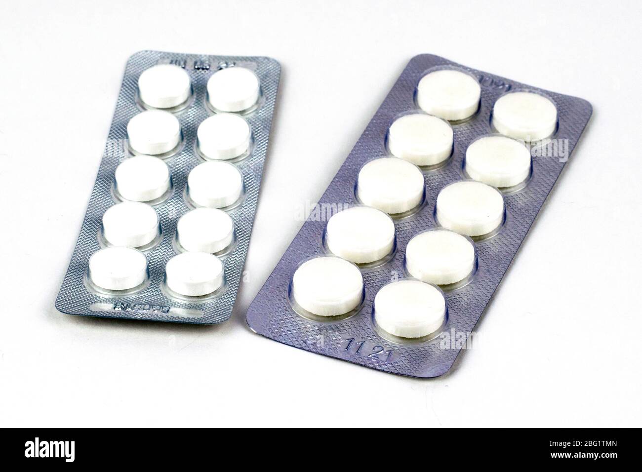 two blisters with white pills on a white background Stock Photo - Alamy