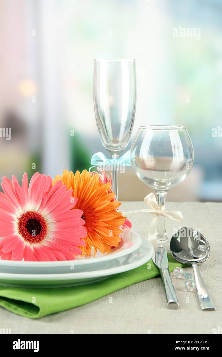Table serving on bright background Stock Photo - Alamy