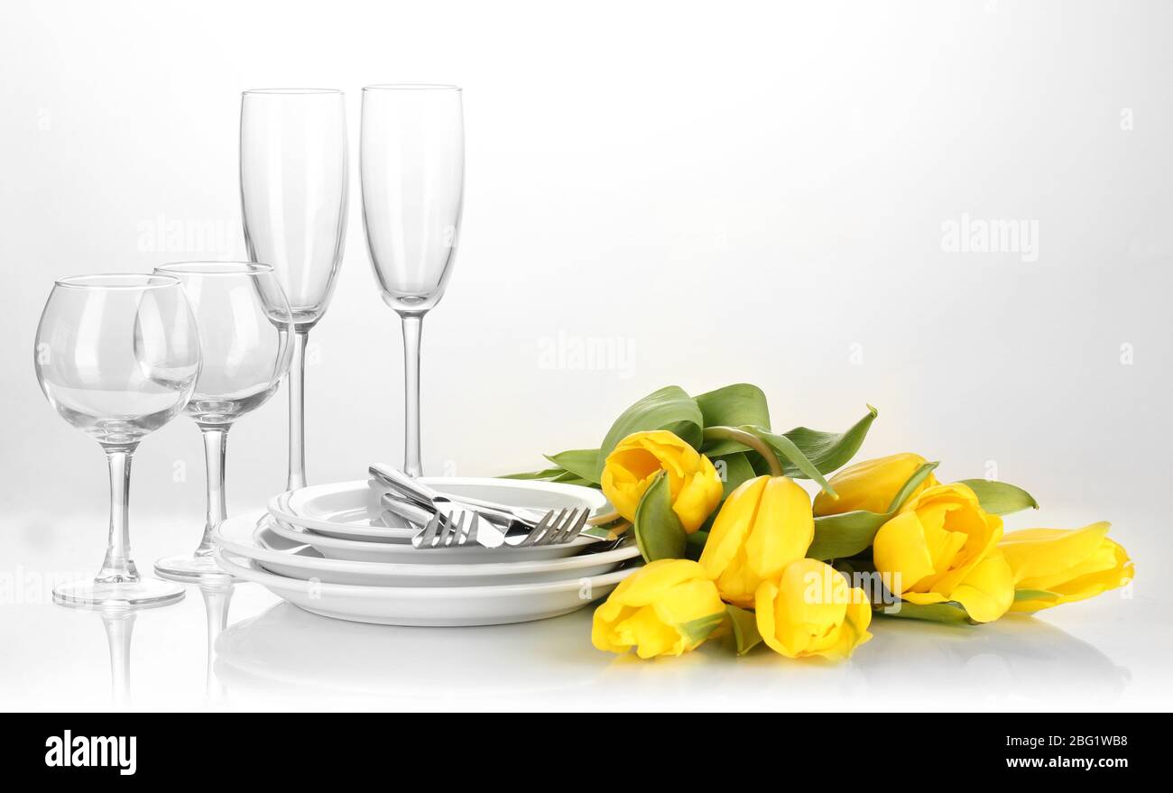 Yellow tulips and utensils for serving isolated on white Stock Photo ...