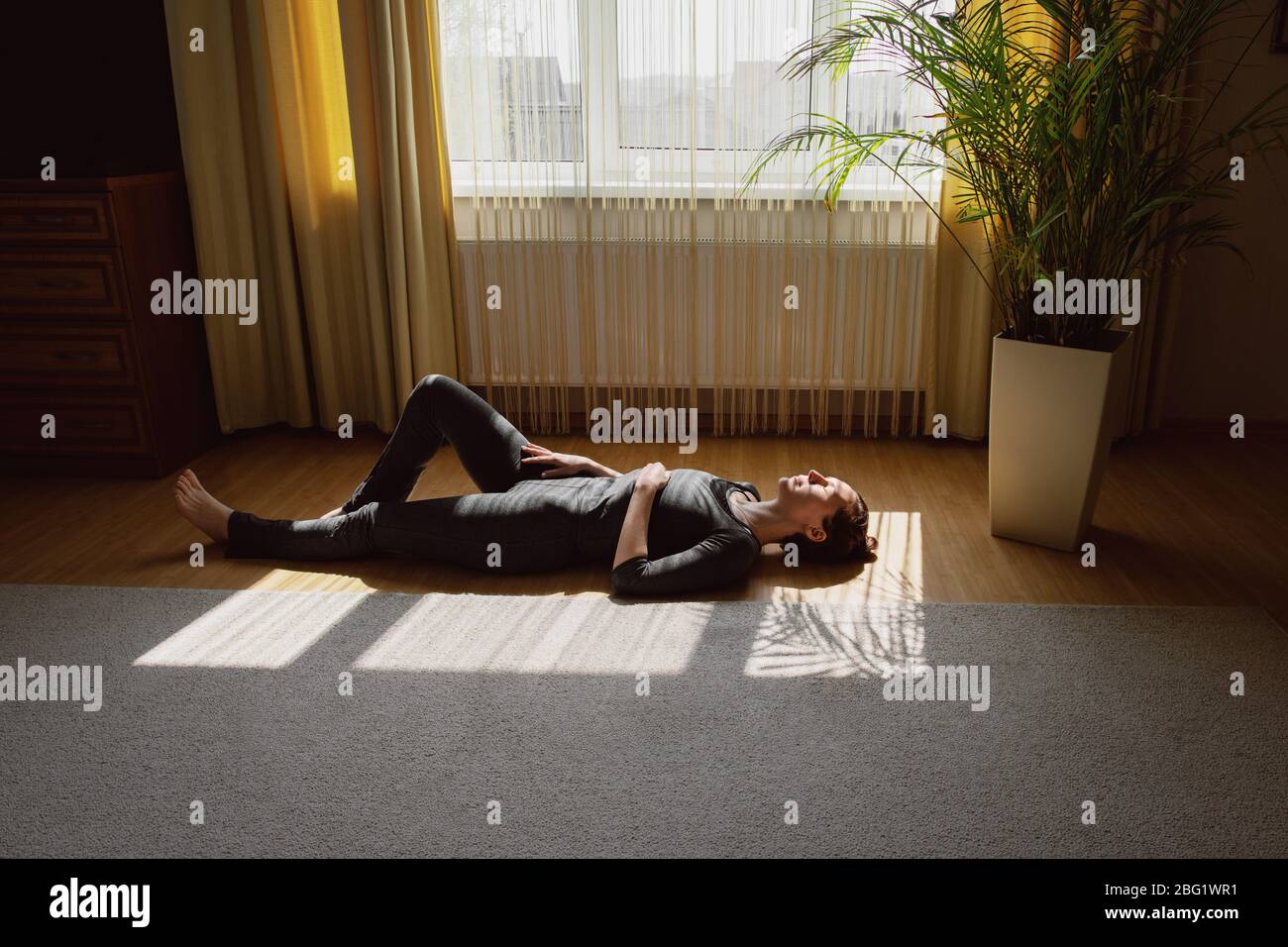 Woman lying exhausted on the floor after workout Stock Photo - Alamy