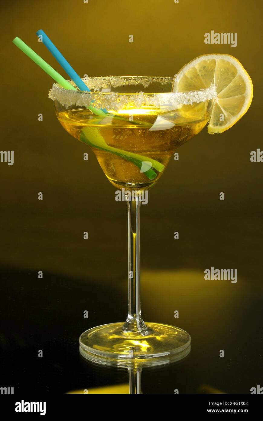 Yellow cocktail in glass on color background Stock Photo - Alamy