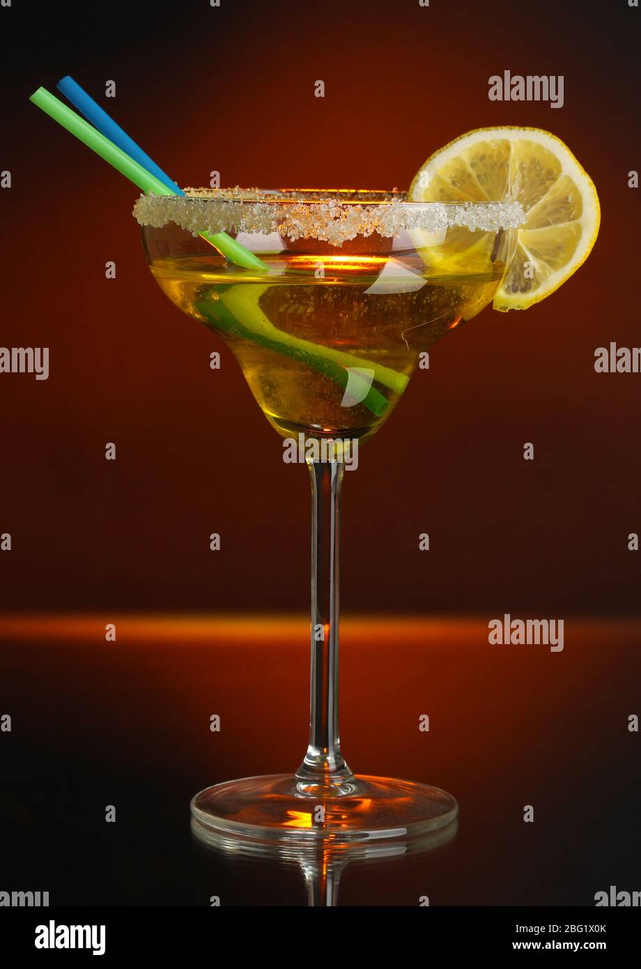 Yellow cocktail in glass on color background Stock Photo - Alamy