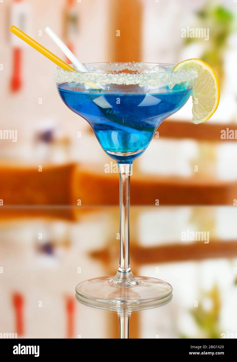 Blue cocktail in glass on room background Stock Photo - Alamy