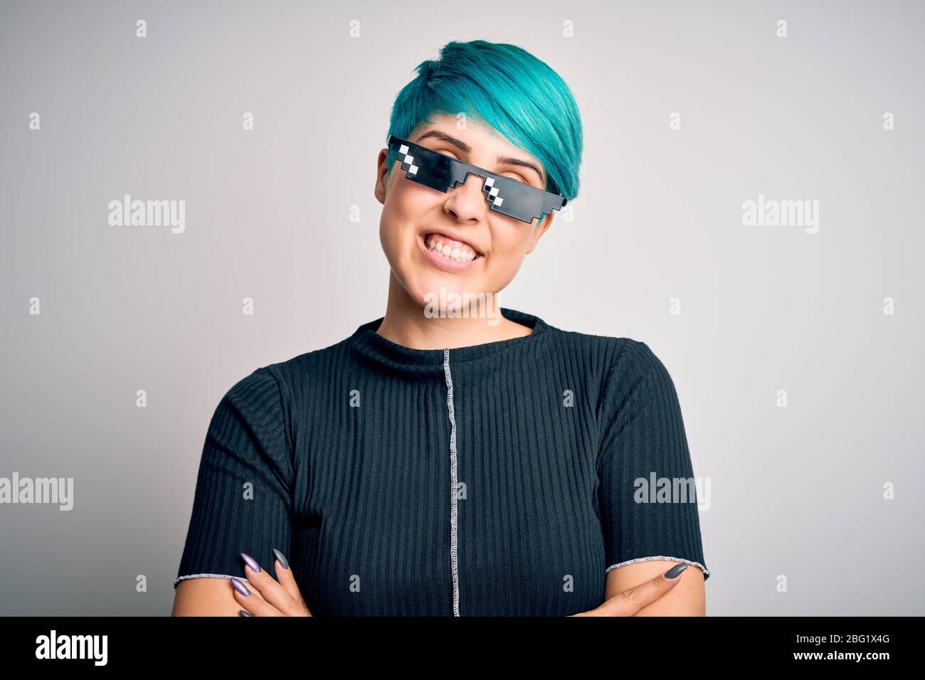 Young woman with blue fashion hair wearing thug life sunglasses over ...