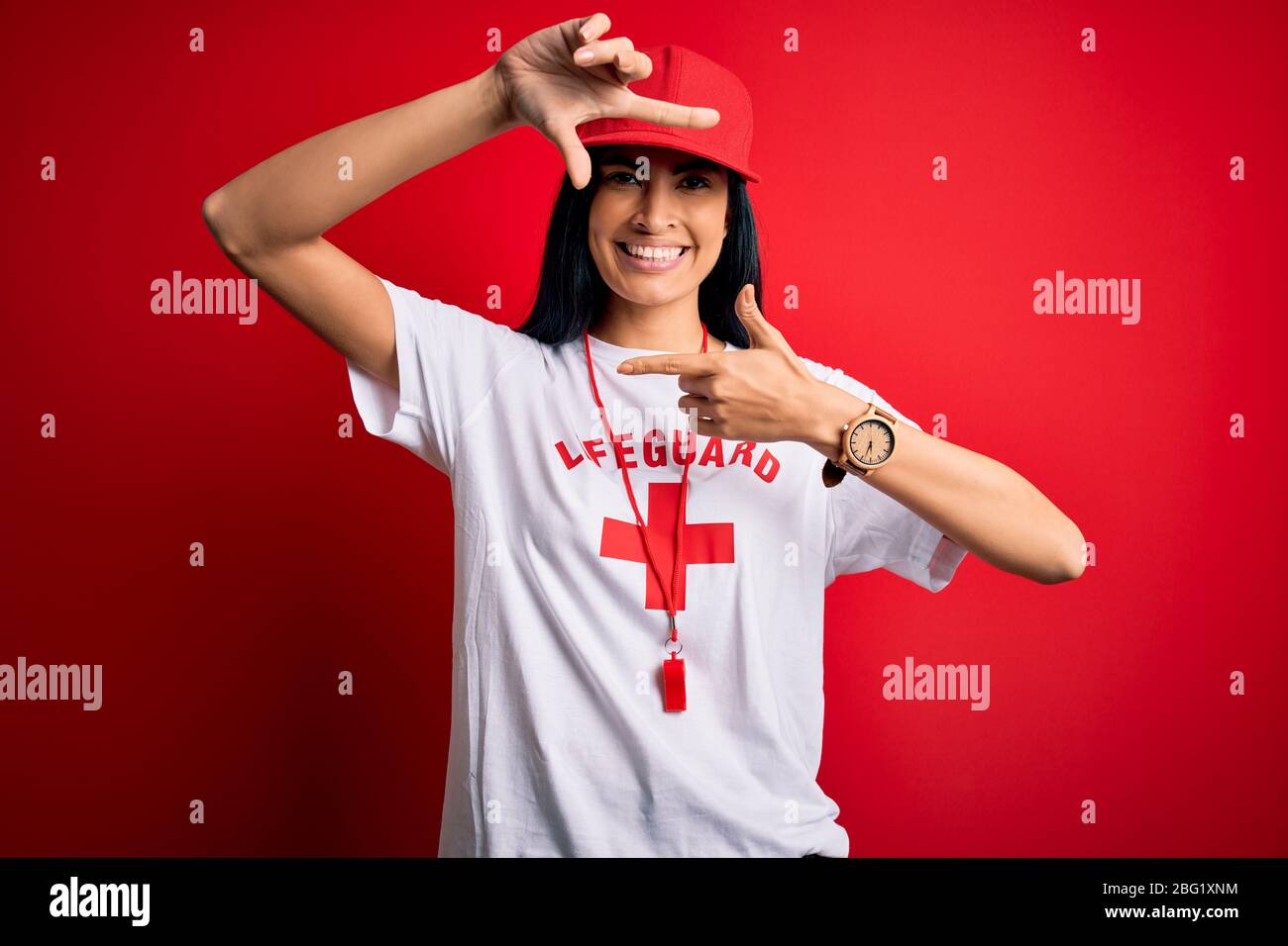 Young beautiful hispanic lifeguard woman wearing safeguard t-shirt and ...