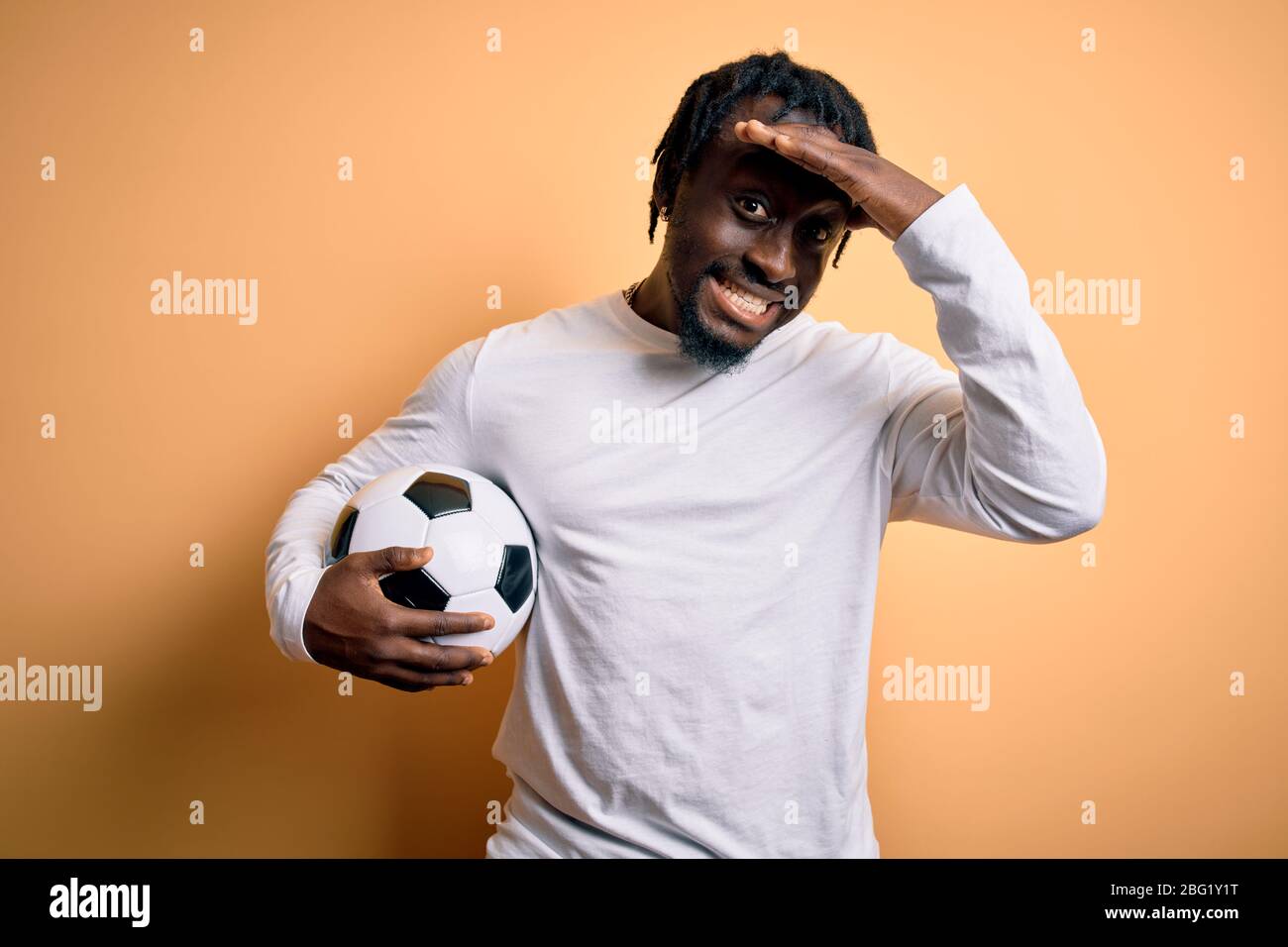 Young african american player man playing soccer holding football ball ...