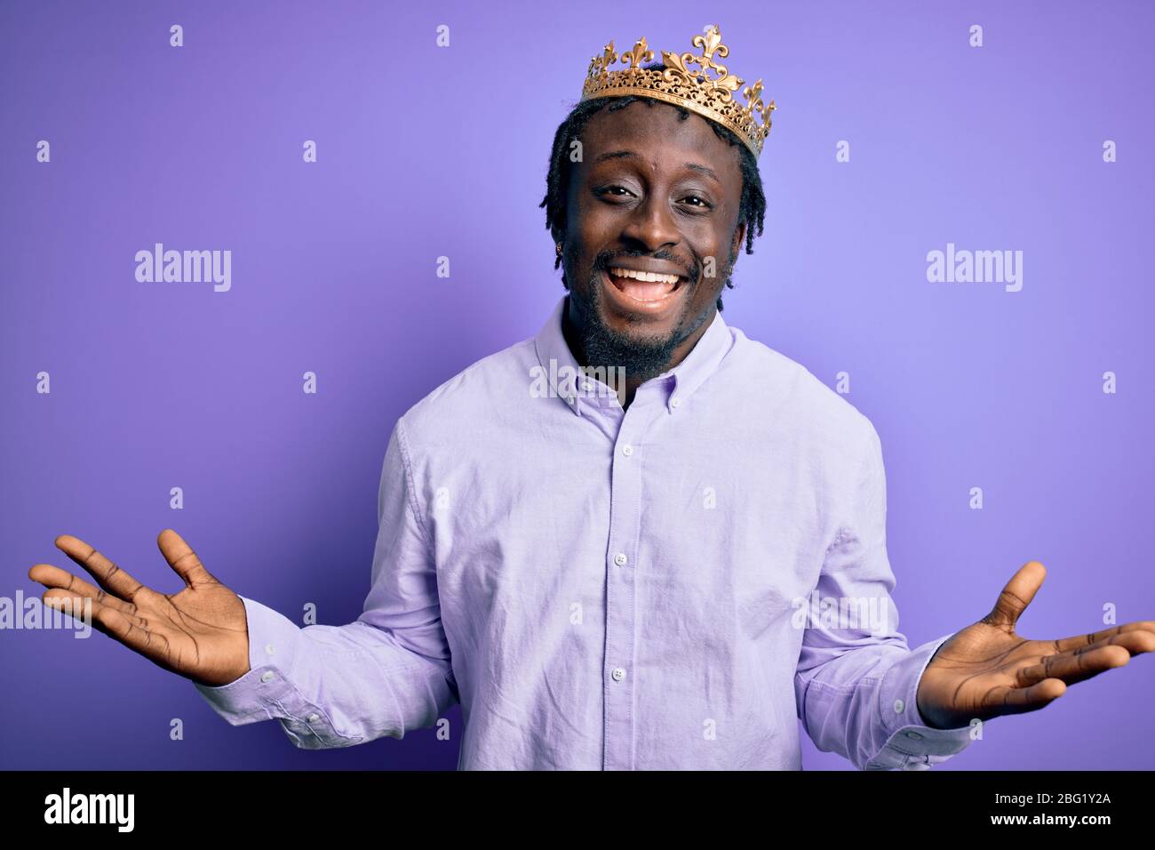 Young african american man wearing golden crown of king over isolated ...