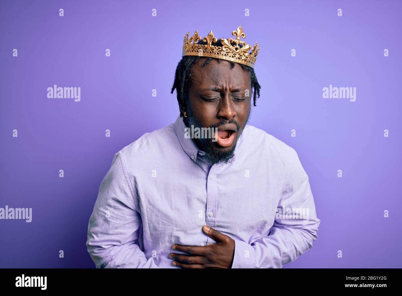 Young african american man wearing golden crown of king over isolated ...