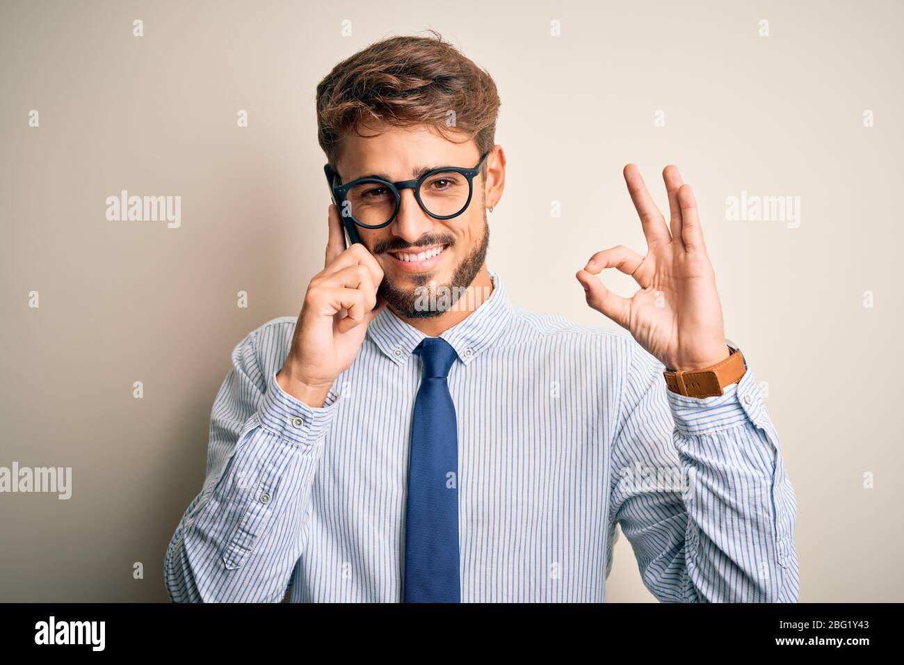 Young businessman having a conversation talking by smartphone over ...