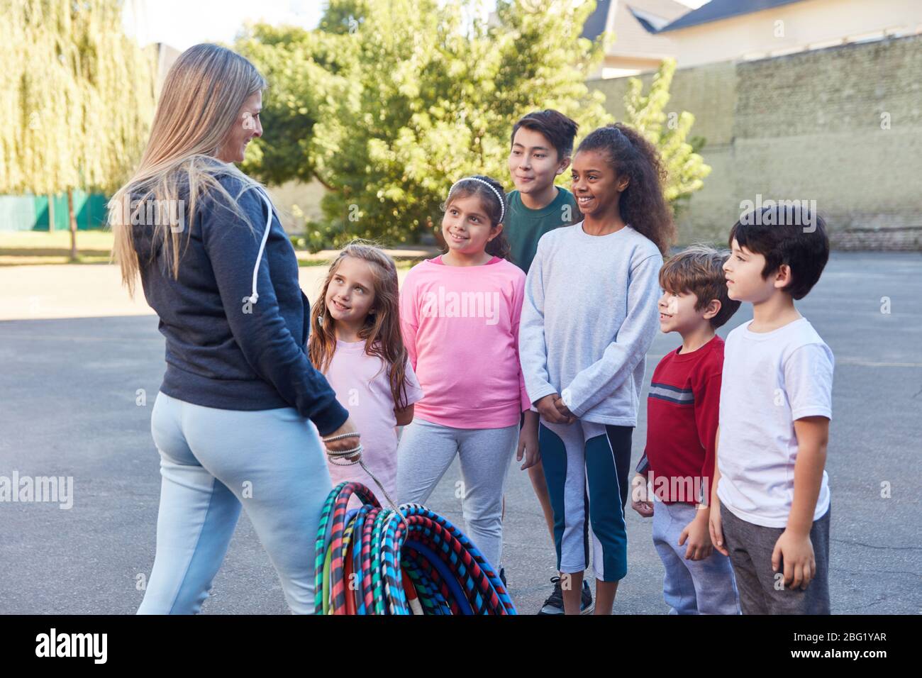 Children doing physical education in elementary school with sports ...