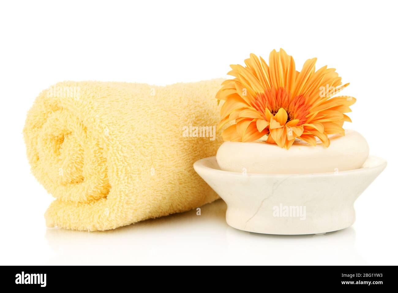 Rolled towel, soap bar and beautiful flower isolated on white Stock ...