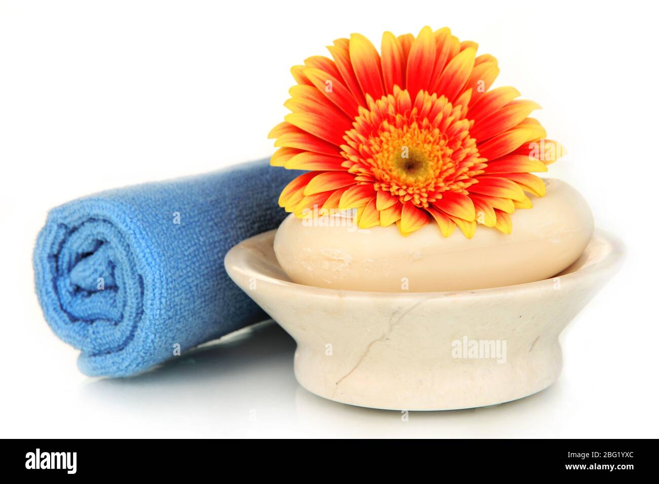 Rolled blue towel, soap bar and beautiful flower isolated on white ...