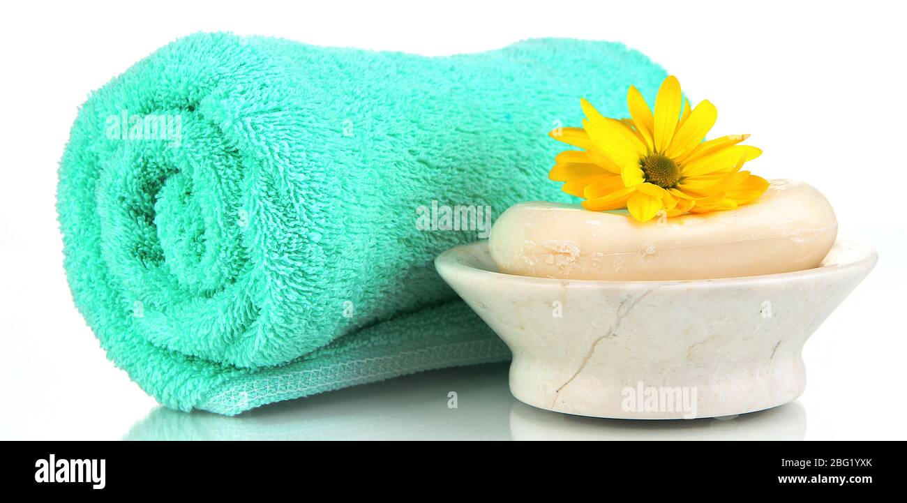 Rolled towel, soap bar and beautiful flower isolated on white Stock ...