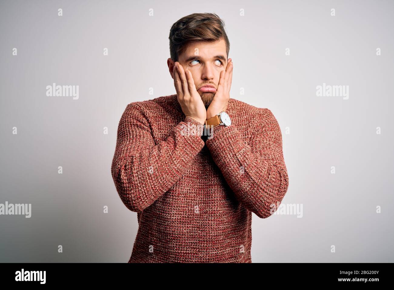 Young blond man with beard and blue eyes wearing casual sweater over ...