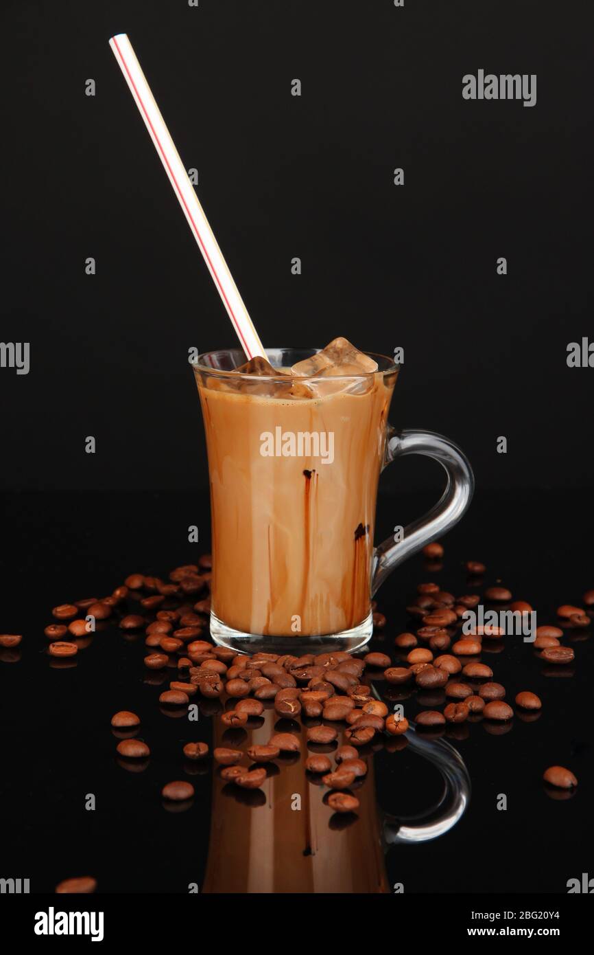 Cold coffee with ice in glass isolated on black Stock Photo - Alamy
