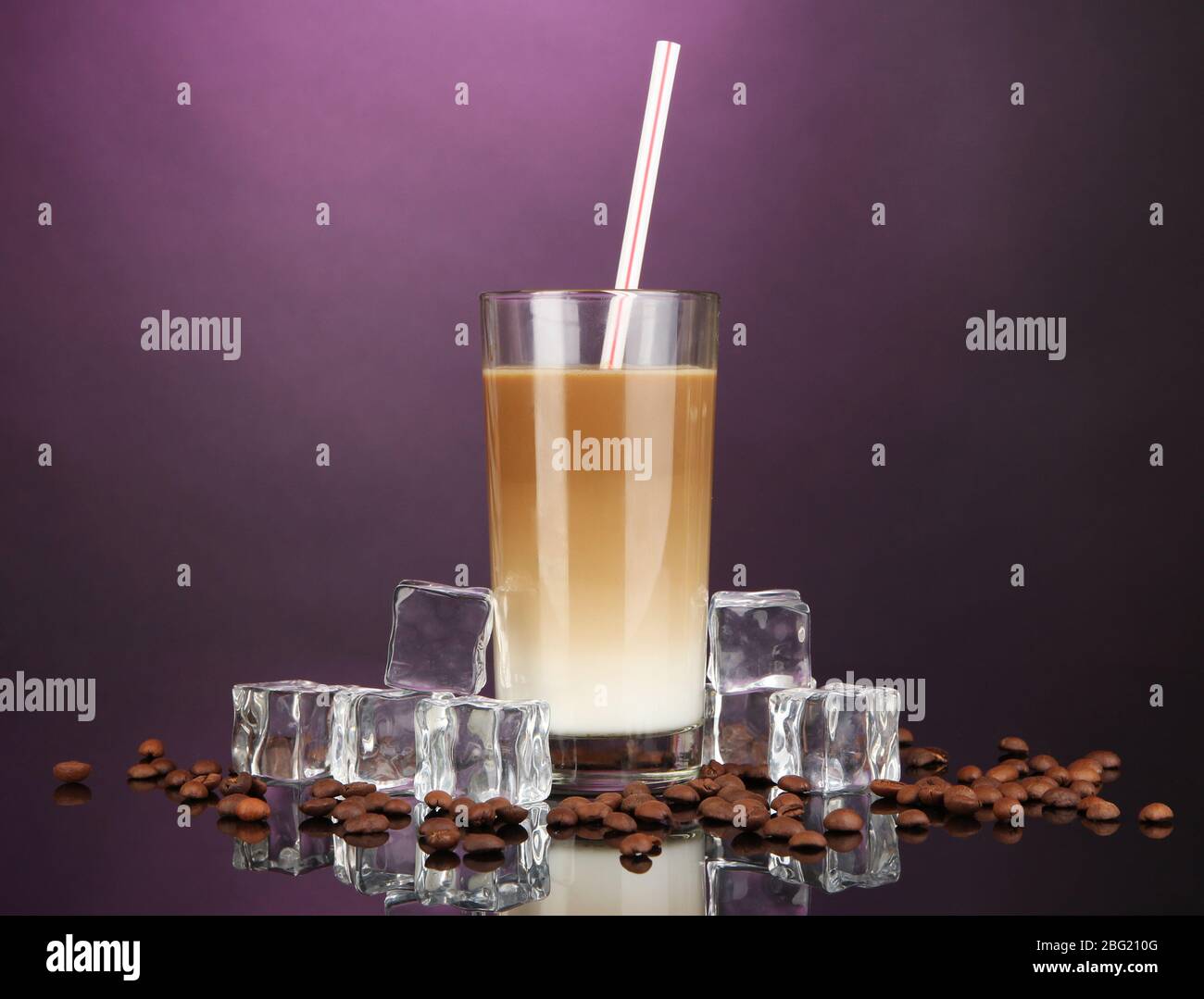 Cold coffee with ice in glass on color background Stock Photo - Alamy