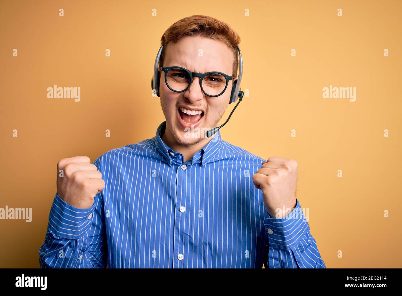 Young handsome redhead call center agent man wearing glasses working ...