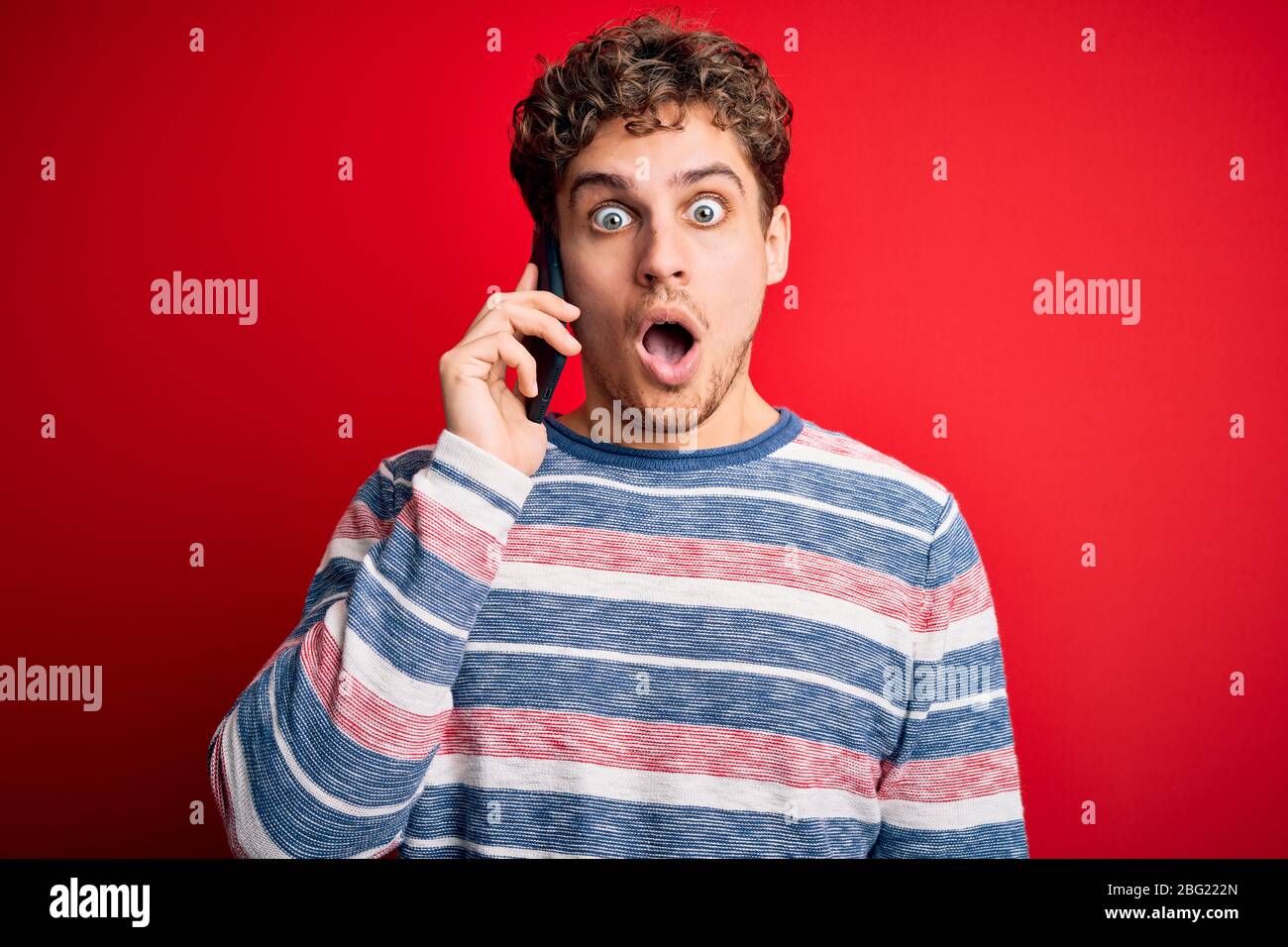Young blond man with curly hair having conversation talking by the ...