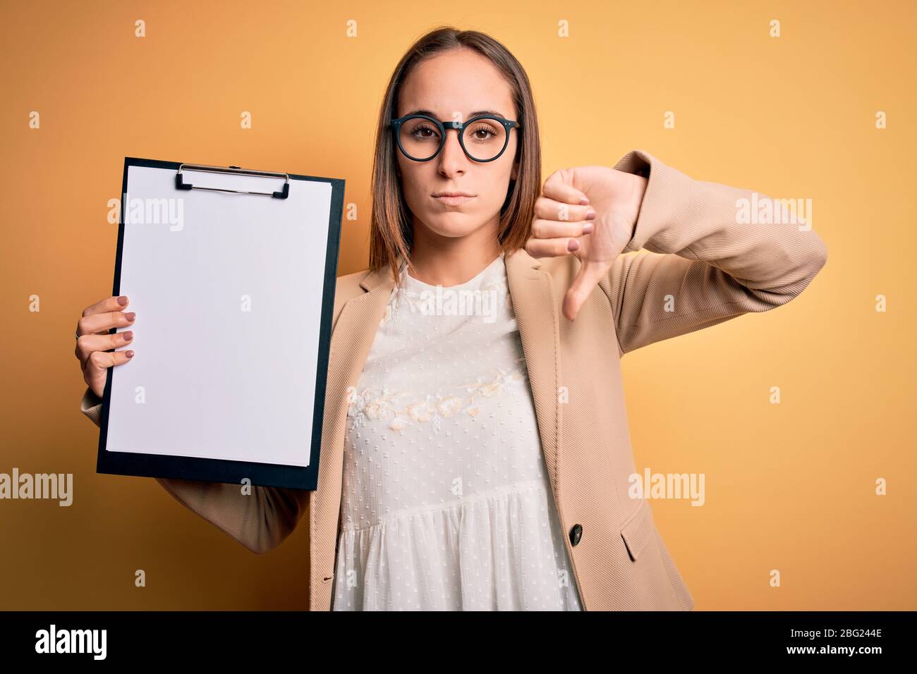 Beautiful inspector woman wearing glasses holding checklist clipboard ...