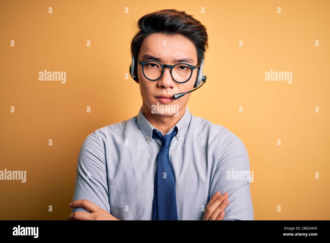 Young handsome chinese call center agent man wering glasses using ...