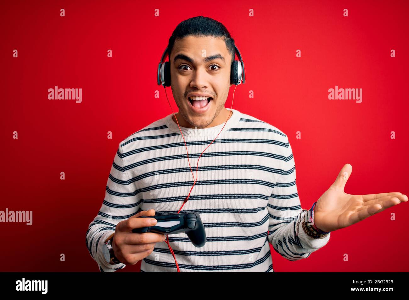 Young brazilian gamer man playing video game using joystick and ...