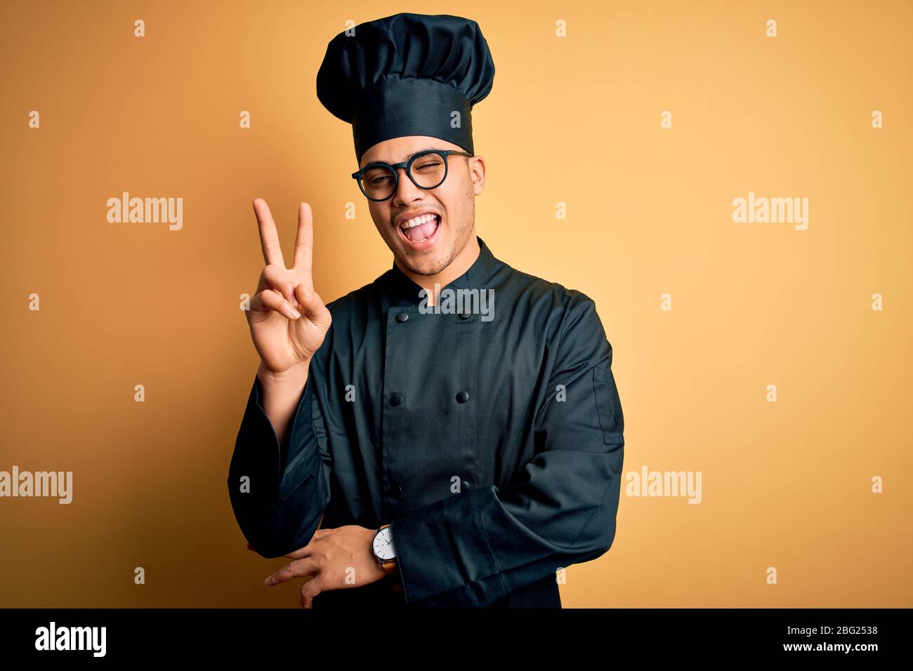 Young brazilian chef man wearing cooker uniform and hat over isolated ...