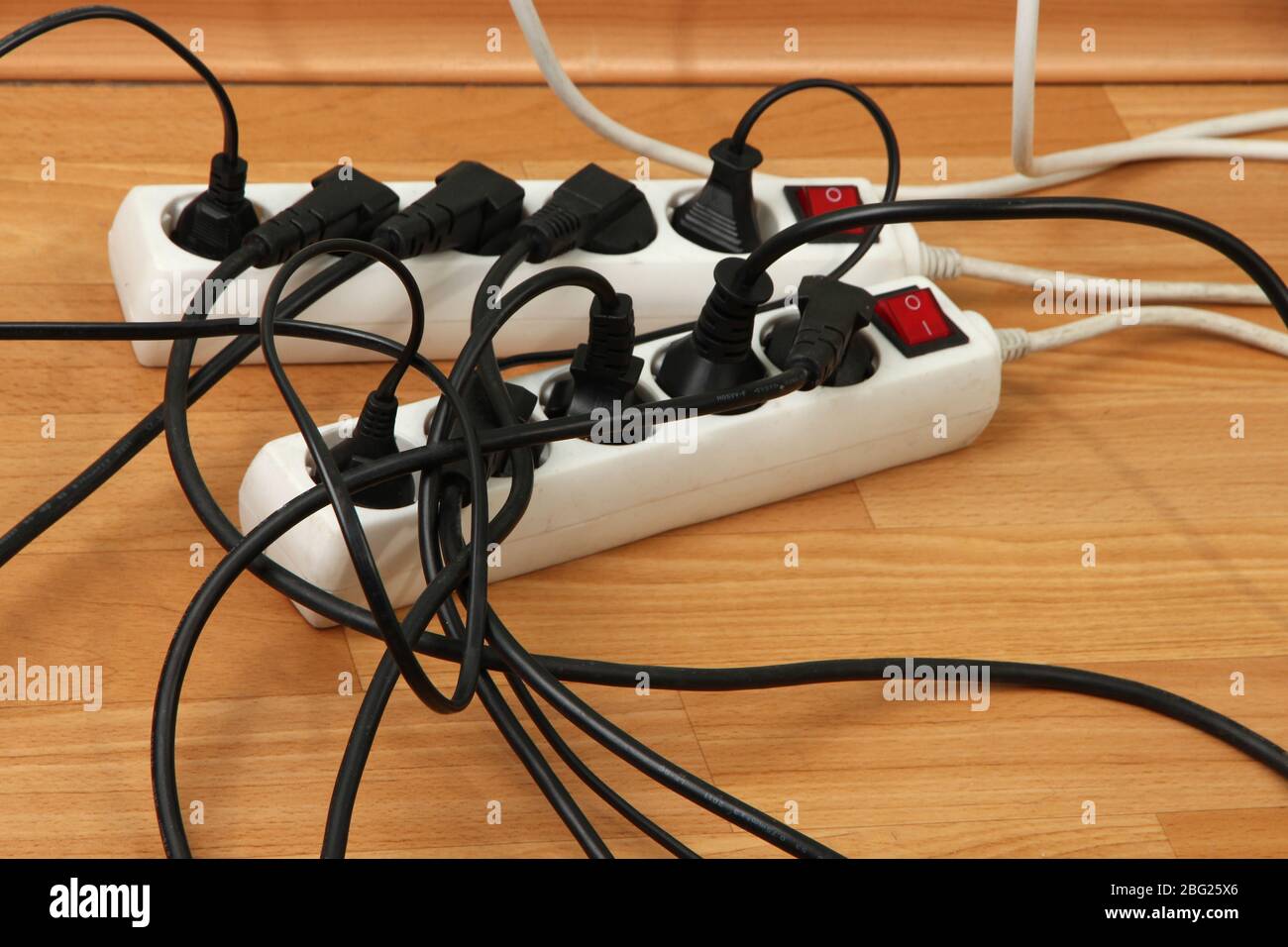 Overloaded power boards, close up Stock Photo - Alamy