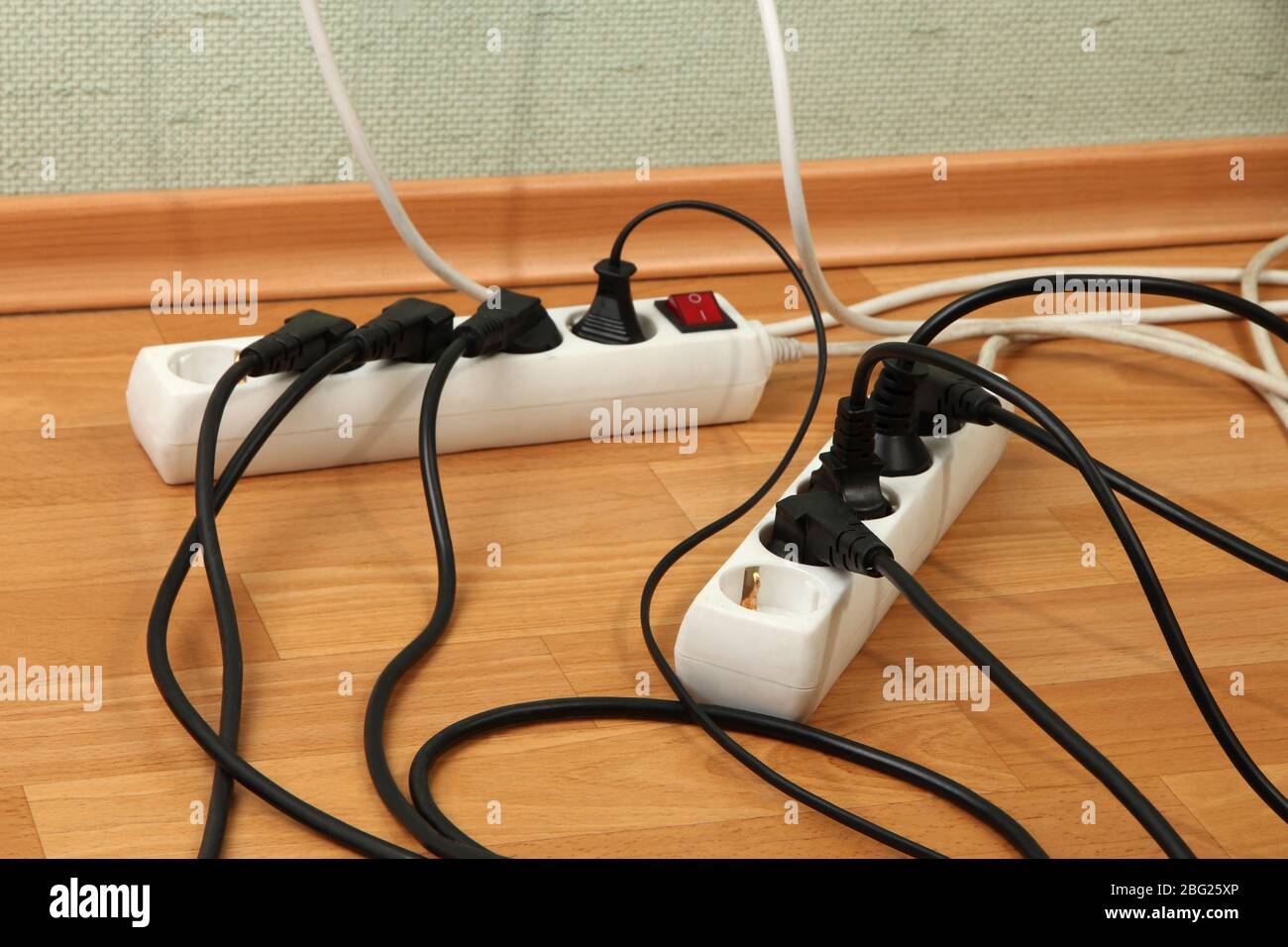 Overloaded power boards, close up Stock Photo - Alamy