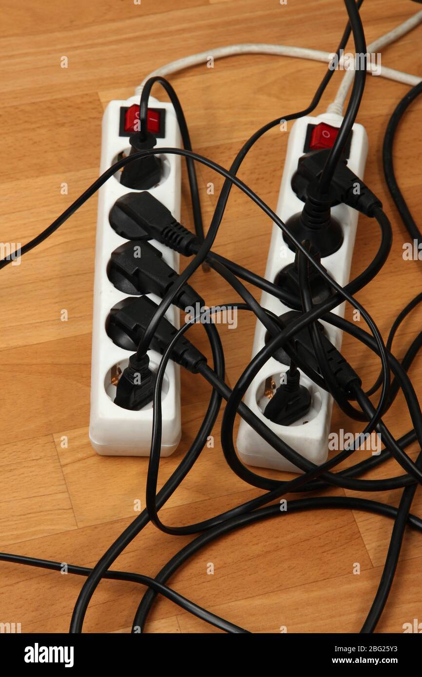 Overloaded power boards, close up Stock Photo - Alamy